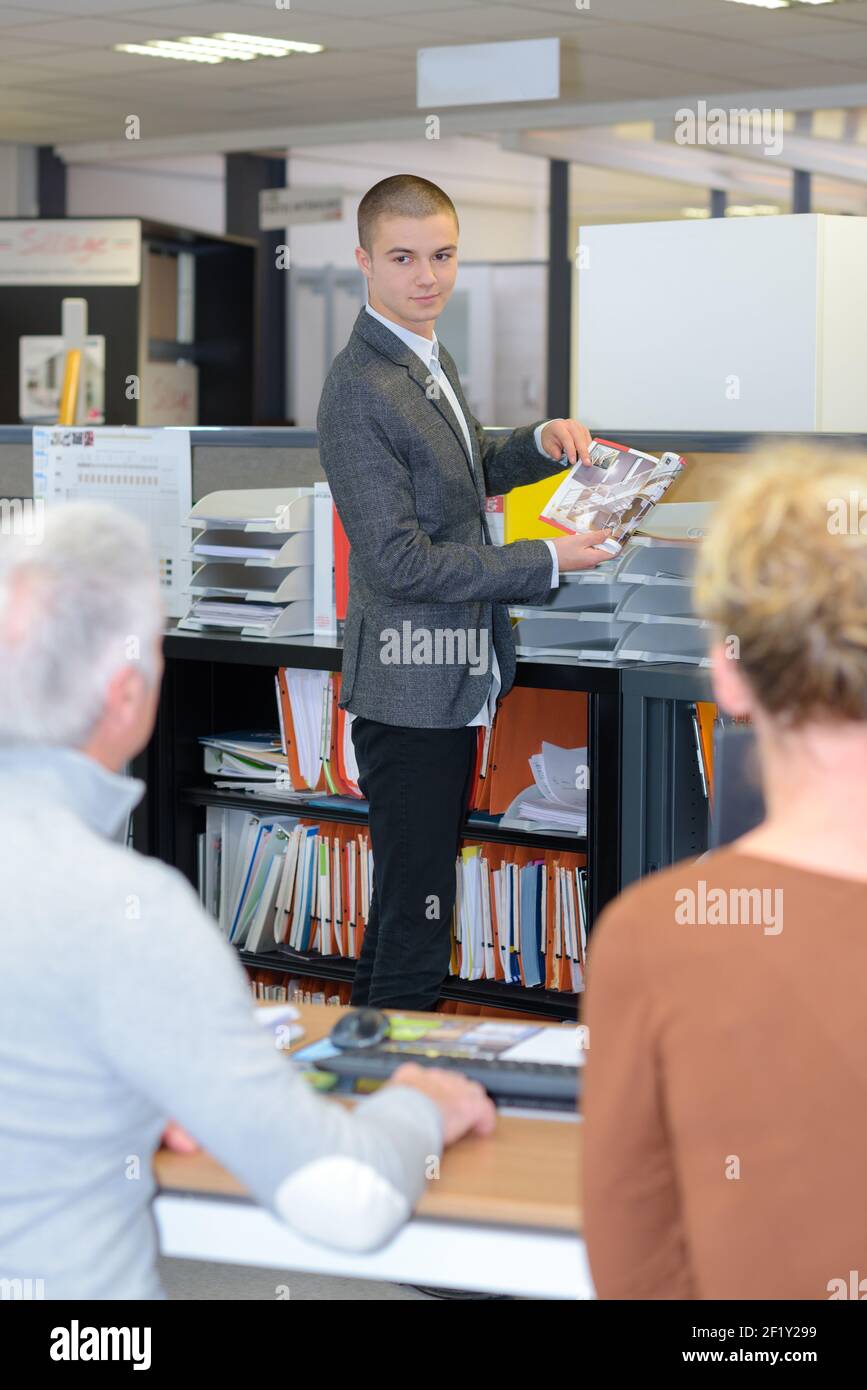 salesman giving a conference to client Stock Photo - Alamy