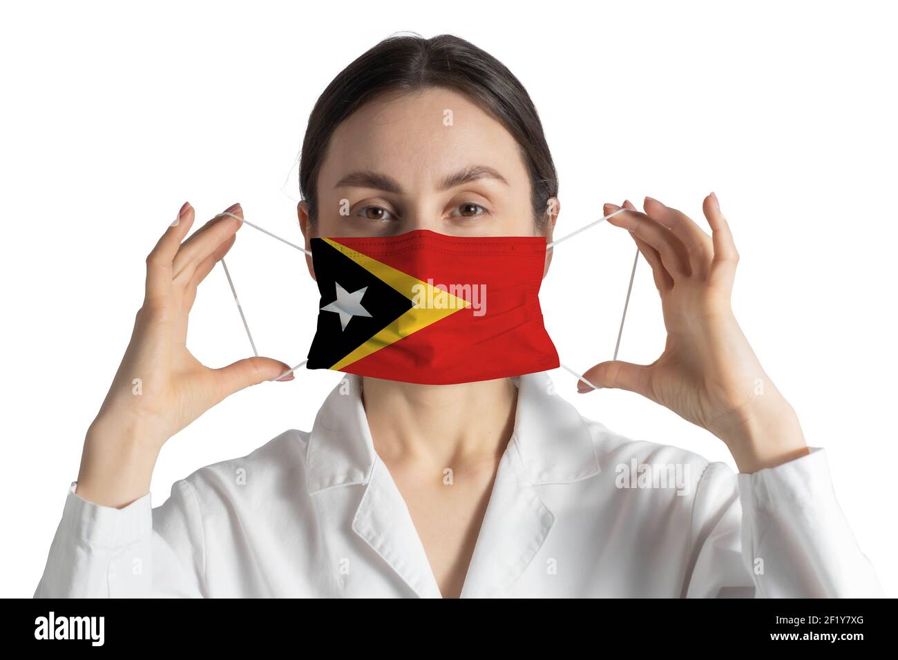 Respirator with flag of East Timor Doctor puts on medical face mask ...