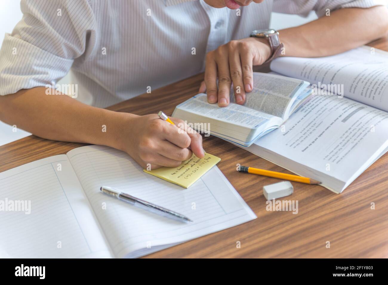 Young man take note in the library Stock Photo - Alamy