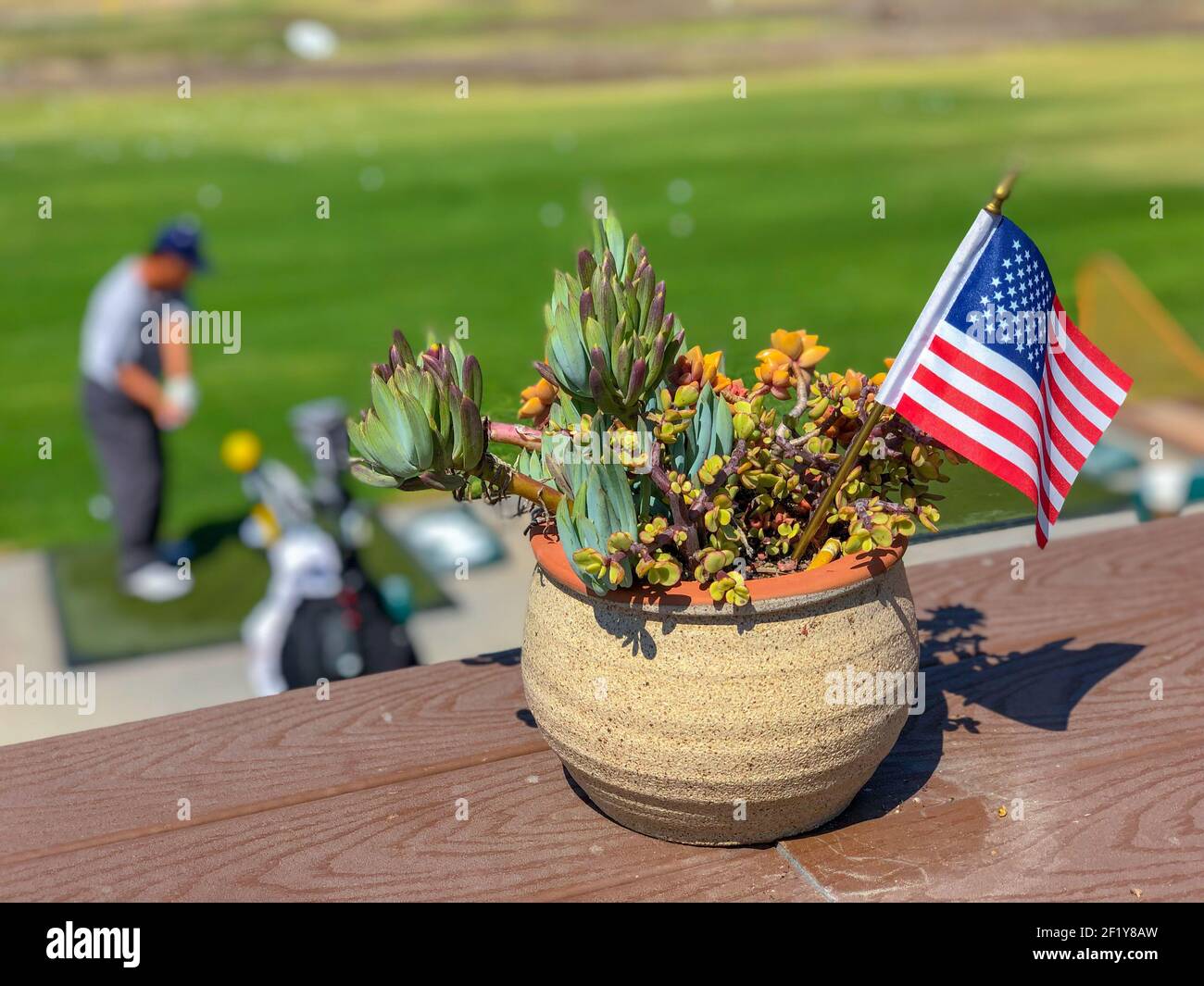 Patriotic flower pot with American flags and golfer on the background ...