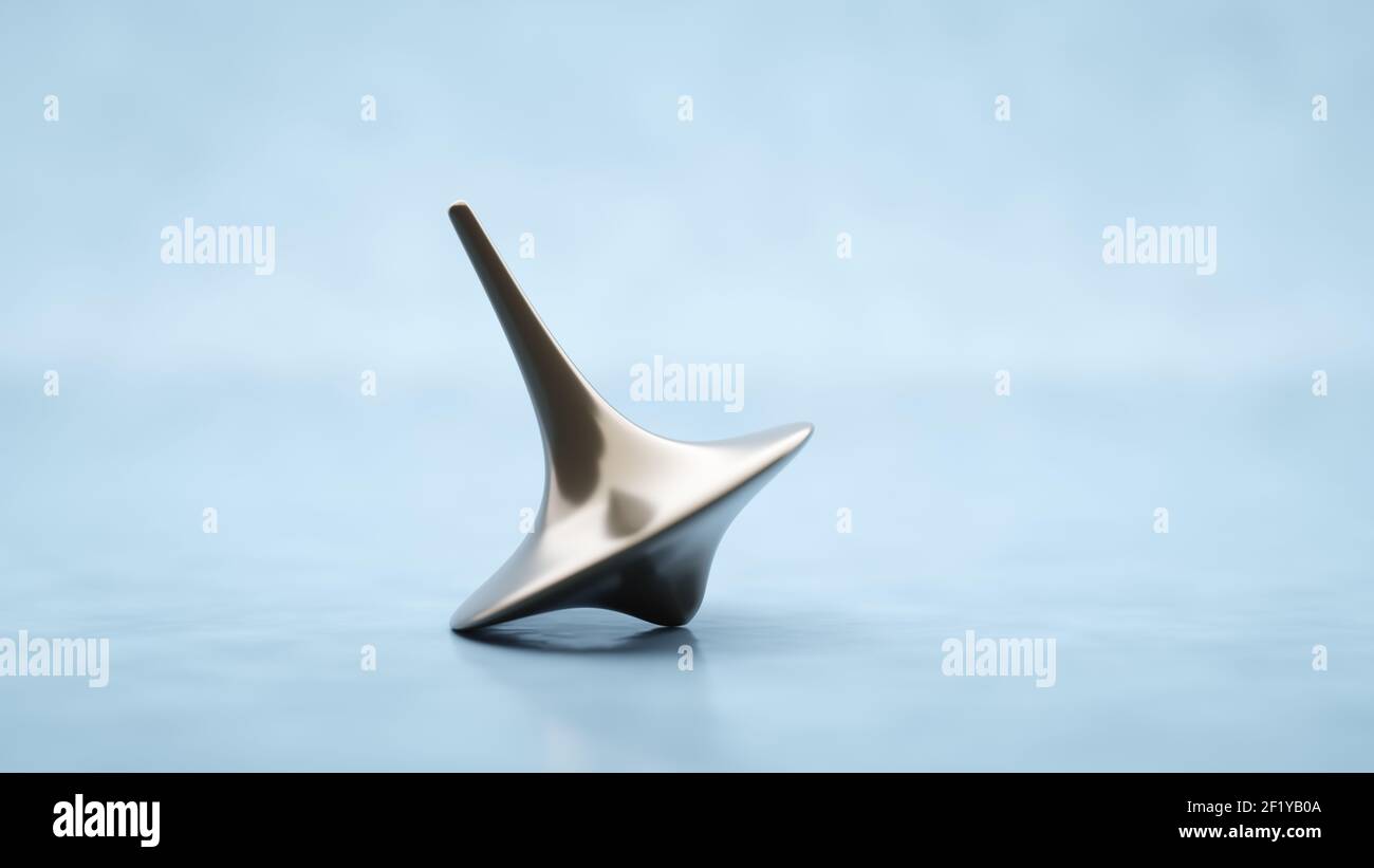 Spinning top on a table Stock Photo - Alamy