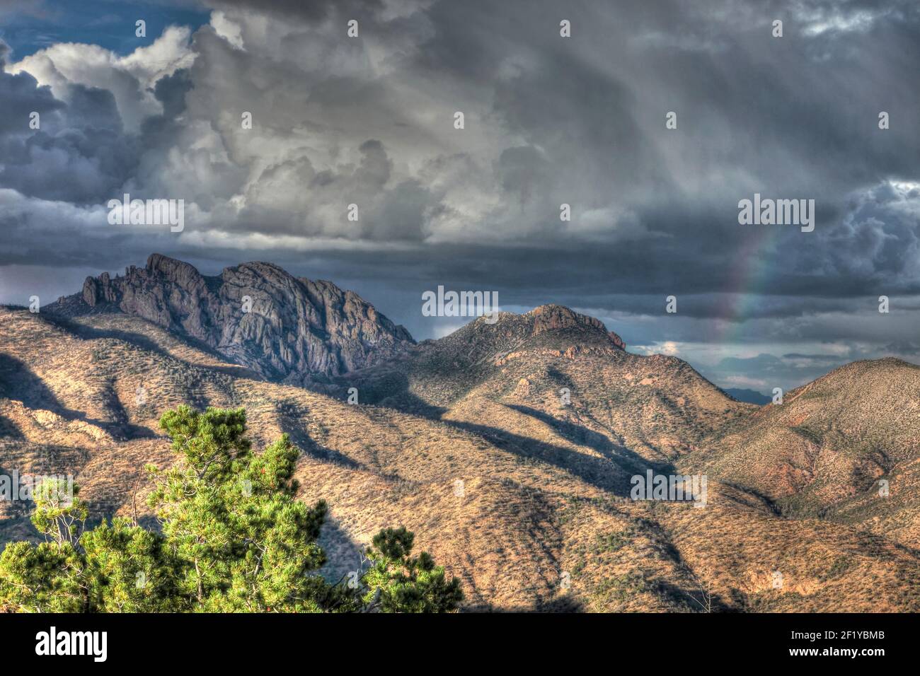 Storm over Cochise Head rock formation with rainbow, Chiricahua ...