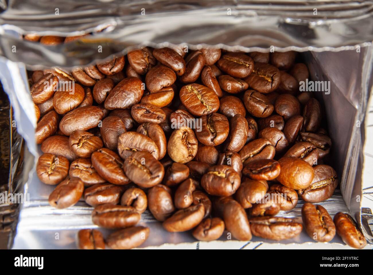 Coffee beans are in an open package. Close-up. Background image Stock ...