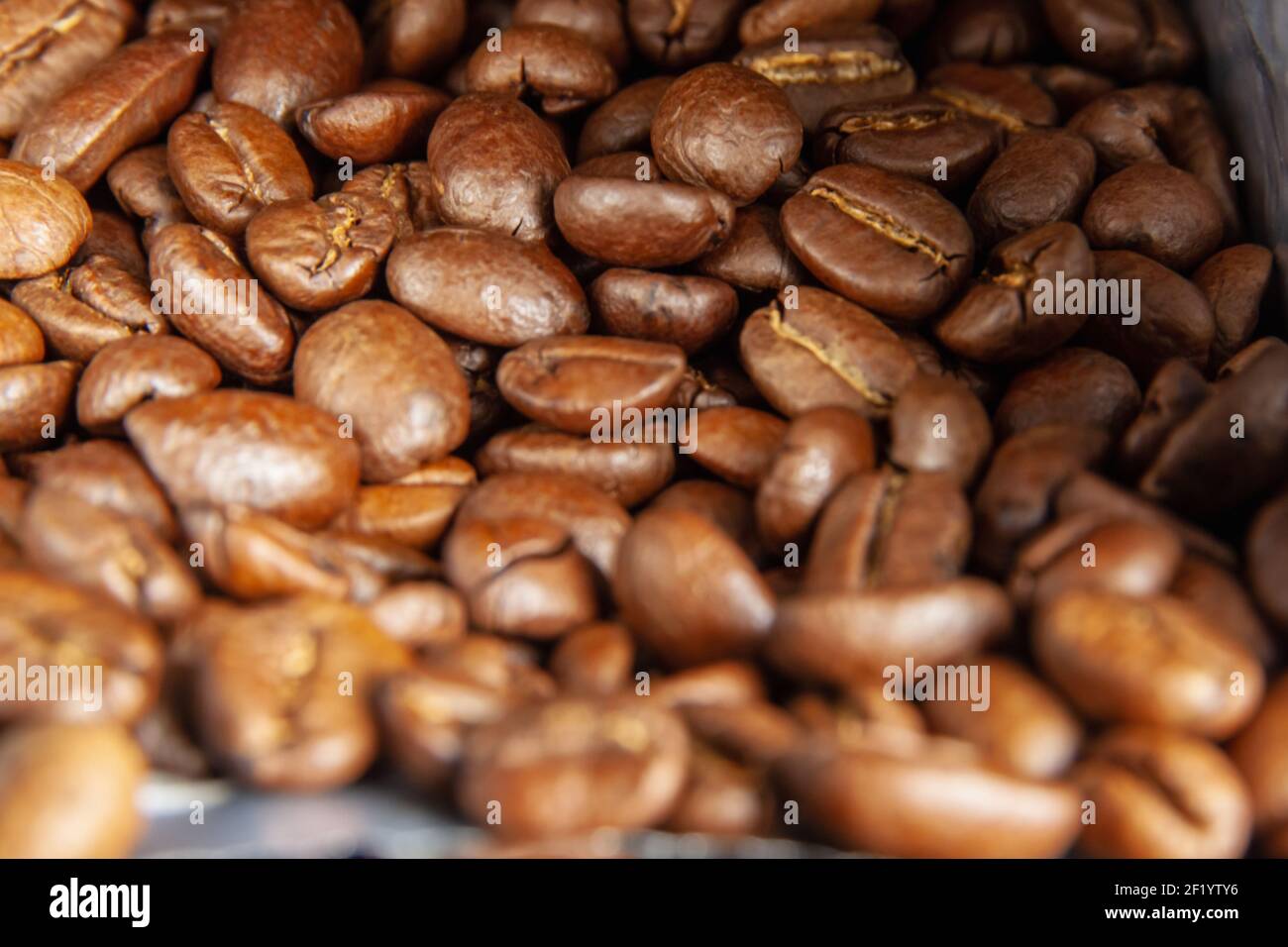Medium-roasted coffee beans close-up in a pack of coffee. Background ...