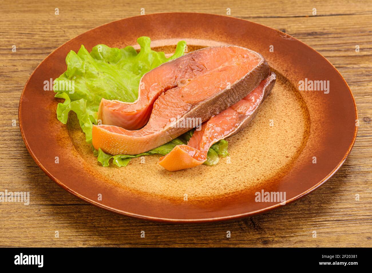Two pink salmon fish steak served salad leaves Stock Photo - Alamy