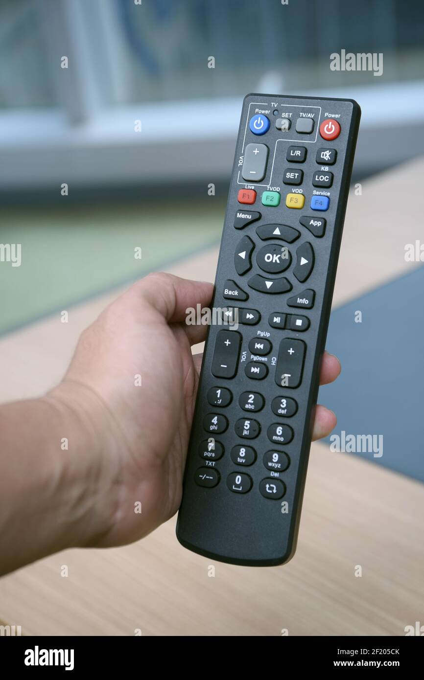 hand holding remote control Stock Photo - Alamy