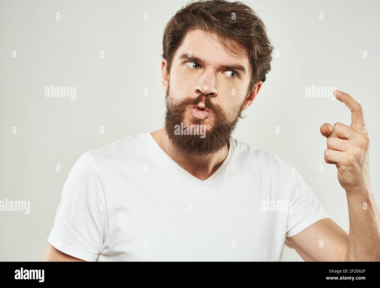 The guy in the T-shirt shows the index finger and emotions model an ...