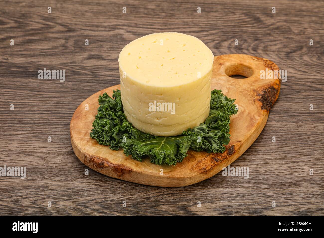 Yellow round dairy soft cheese piece Stock Photo - Alamy