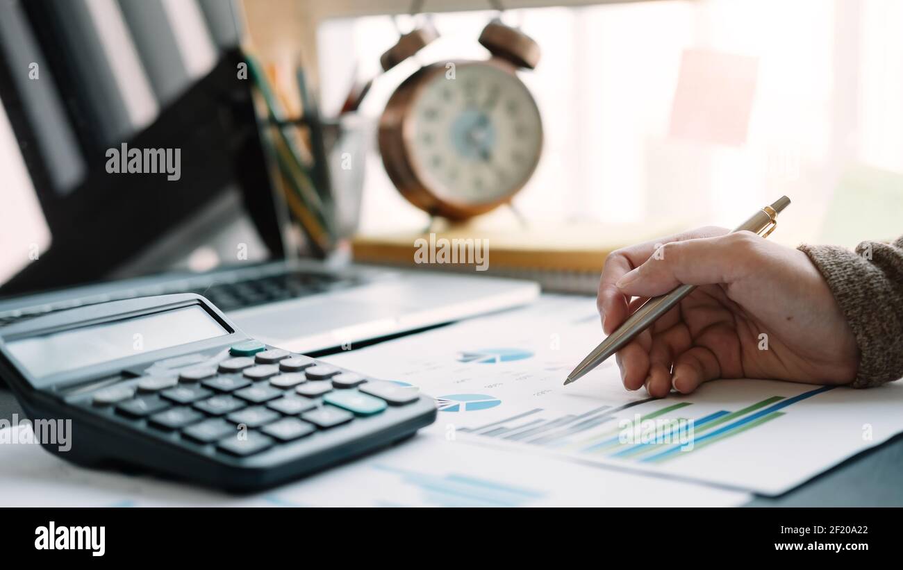 Woman accountant or banker use calculator for calculation financial ...