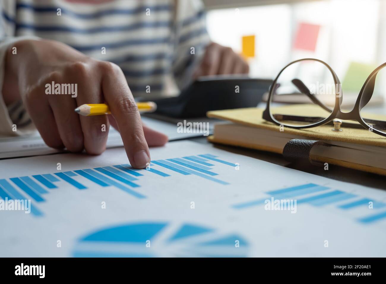 Close up hand of accountant or banker working on calculator to ...