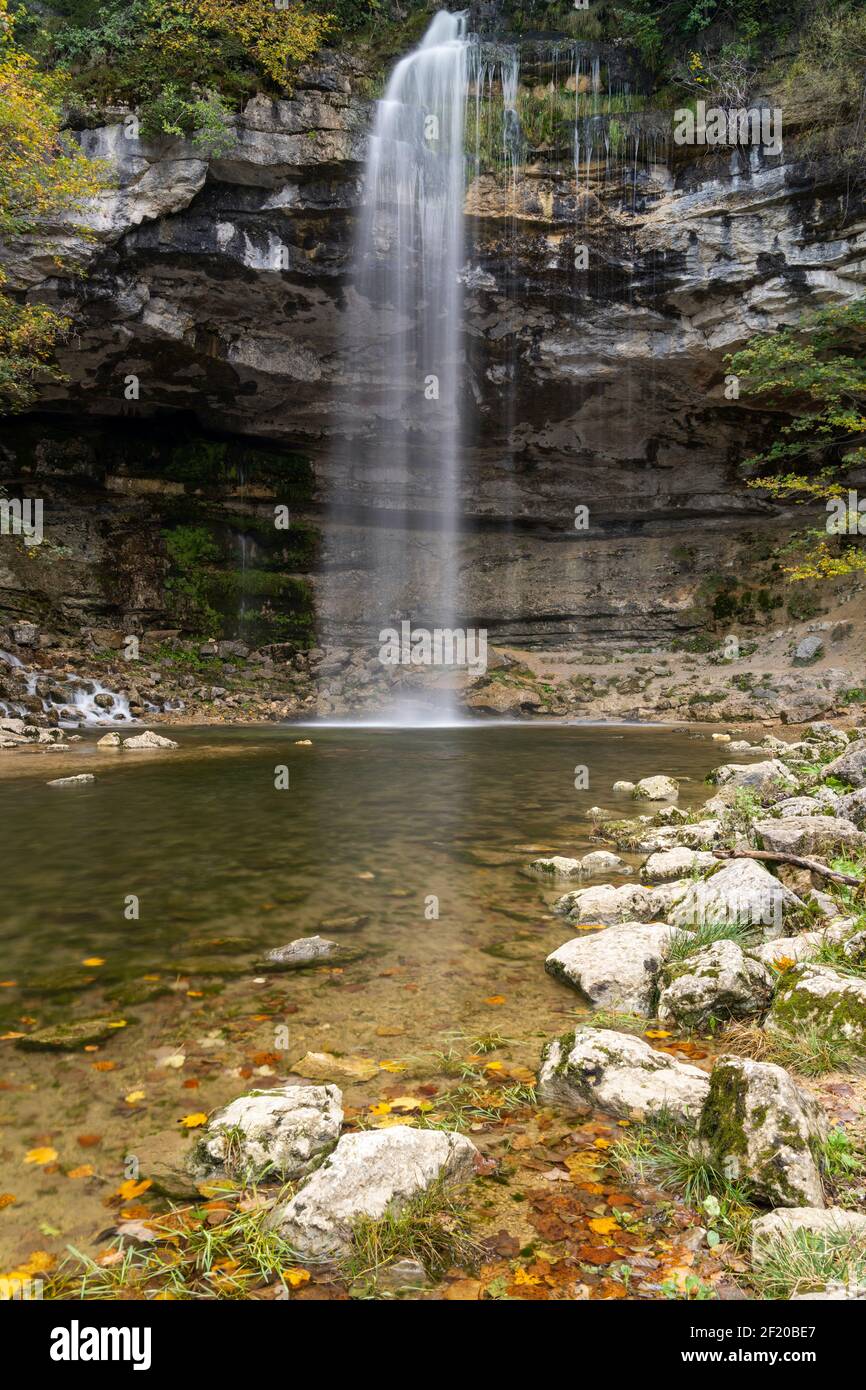 A beautiful autumn forest landscape with idyllic waterfall and pool ...