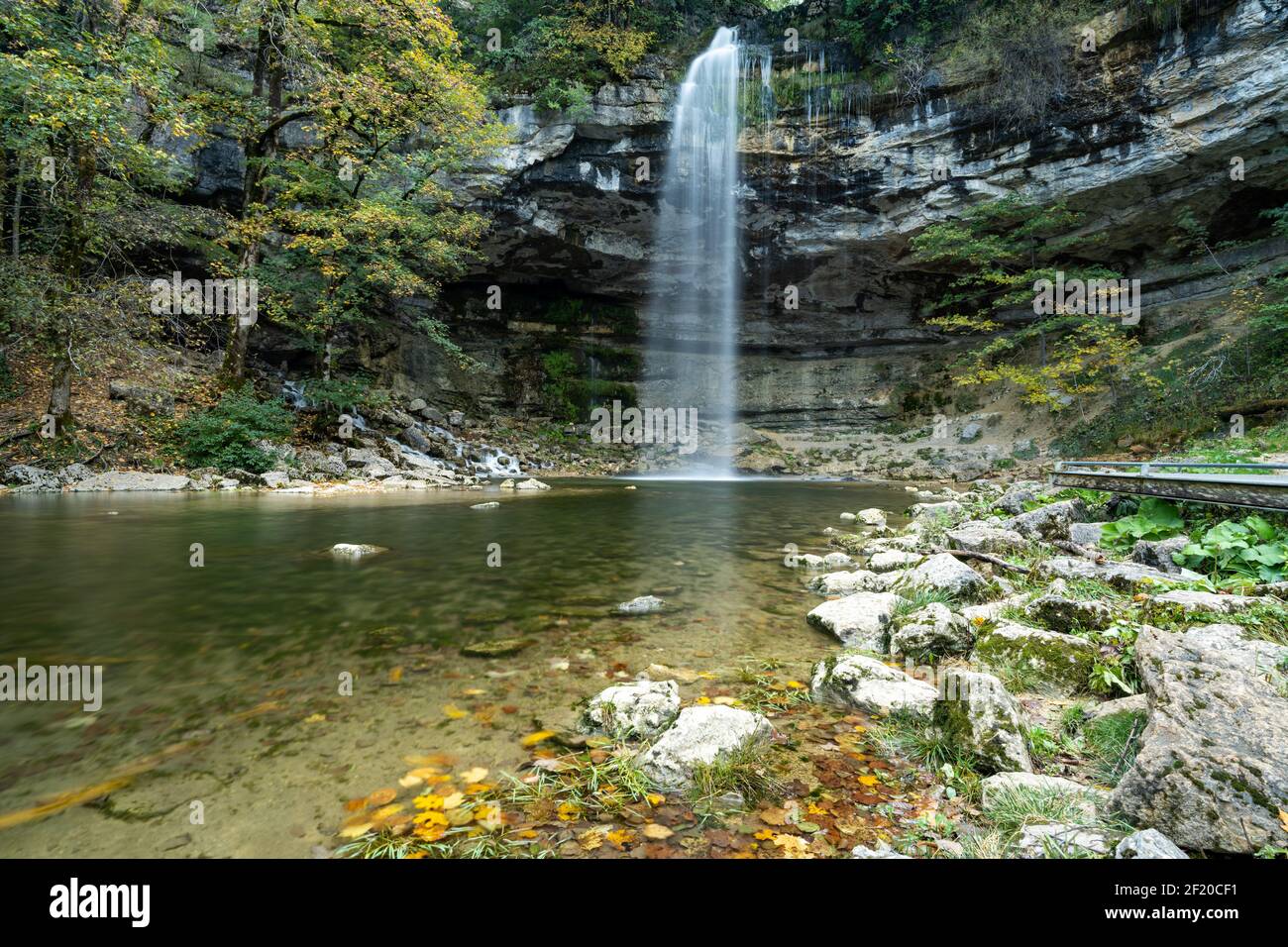 A beautiful autumn forest landscape with idyllic waterfall and pool ...