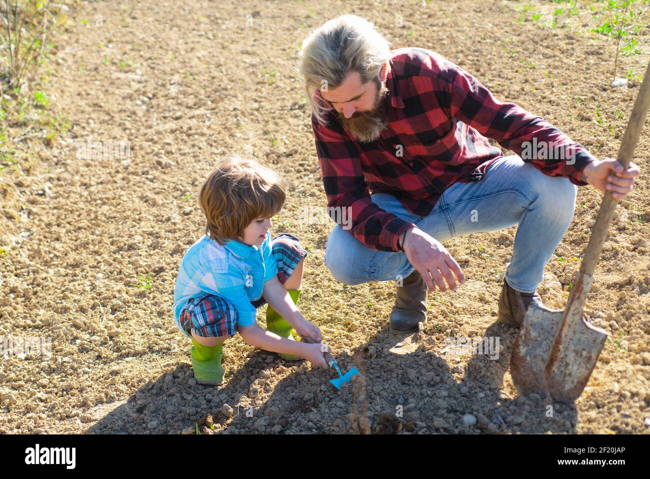 Child father planting hi-res stock photography and images - Alamy