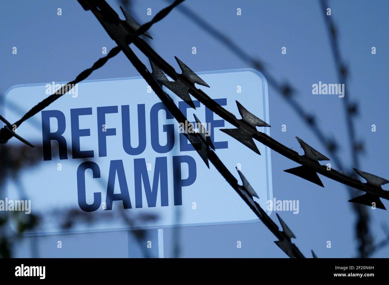 Barbed wire and a plaque with a reference to a refugee camp Stock Photo ...