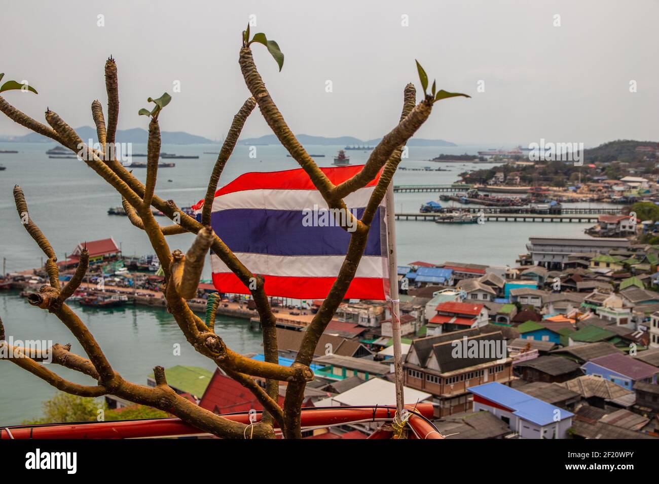 Waving Thai flag at a viewing point on the Thai Island Koh Sichang in ...