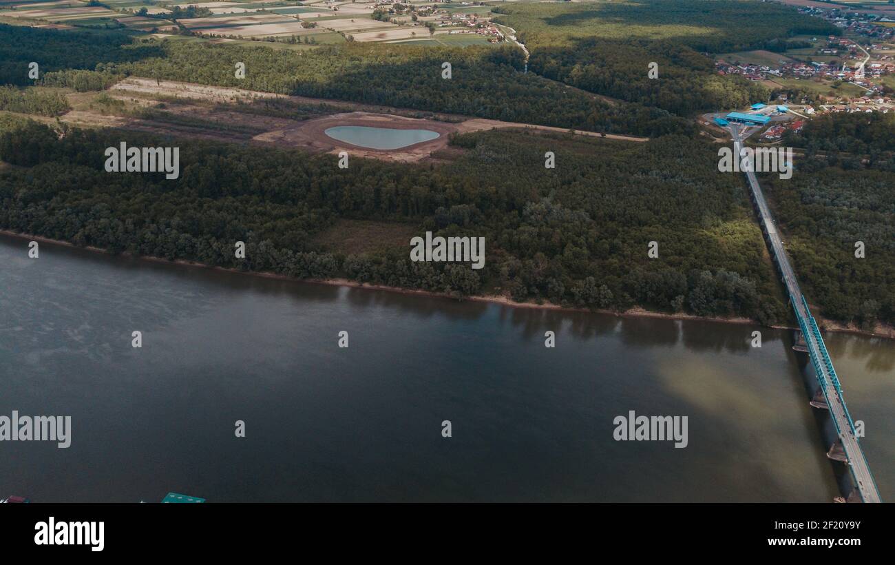 An aerial shot of the Brcko district river and a bridge connecting the ...