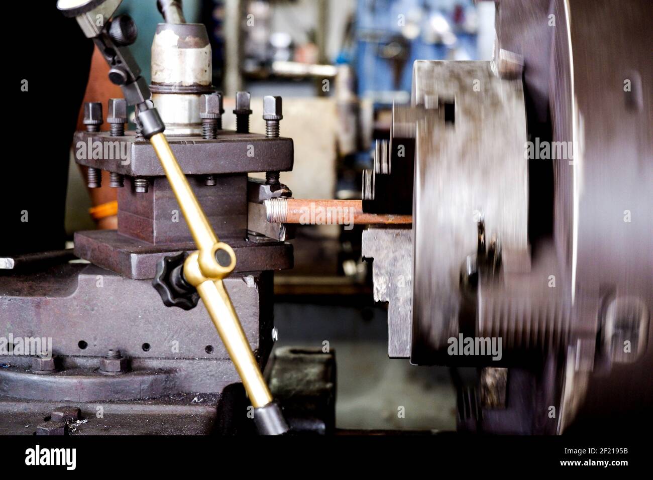 Professional tool technician A landscape of a man using a lathe. Metal ...