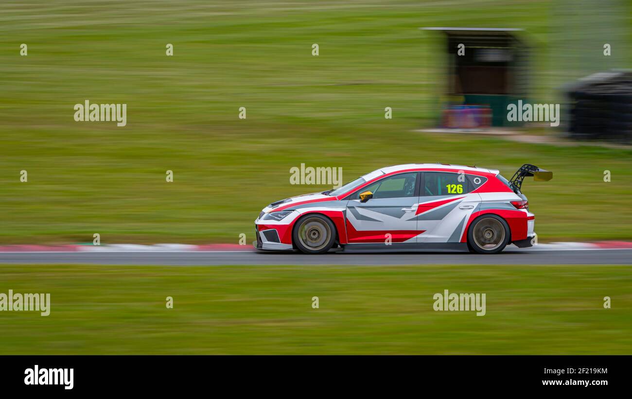 A panning shot of a racing car as it circuits a track Stock Photo - Alamy
