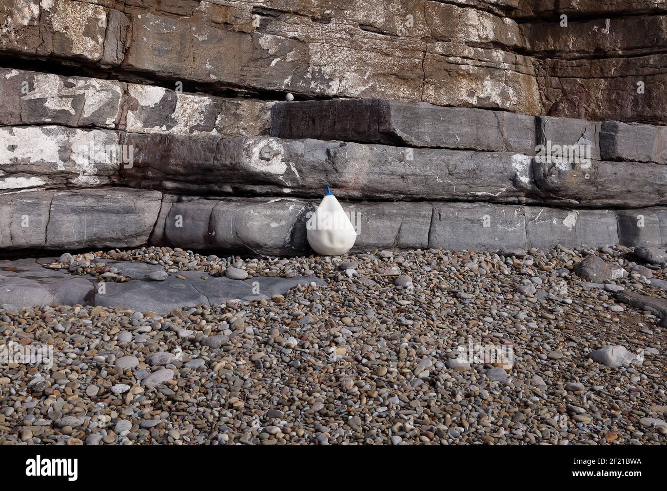 A large white inflated floating marker drifted in on the last tide and ...