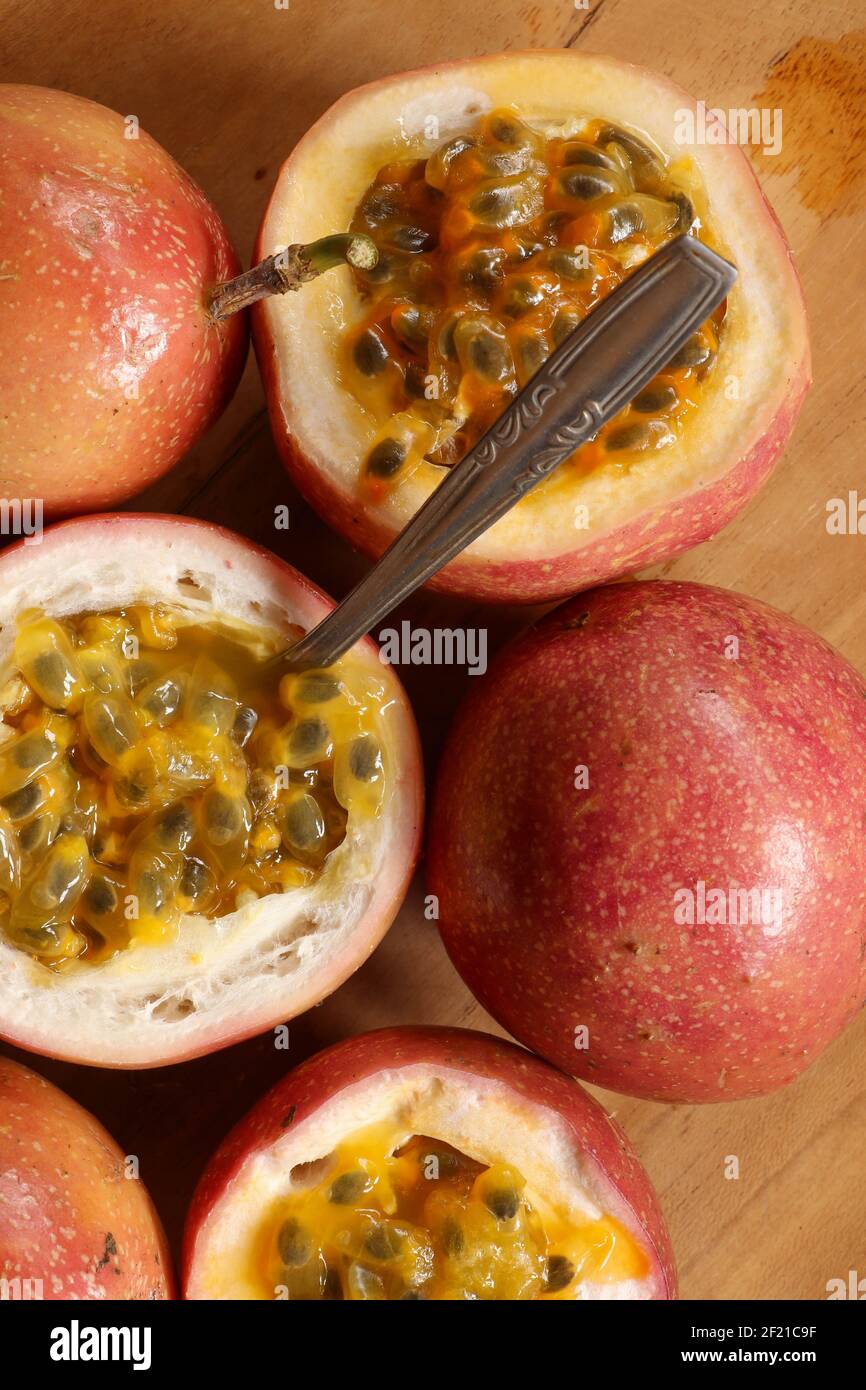 passion fruit pulp with spoon. Passion fruits juice on wooden ...