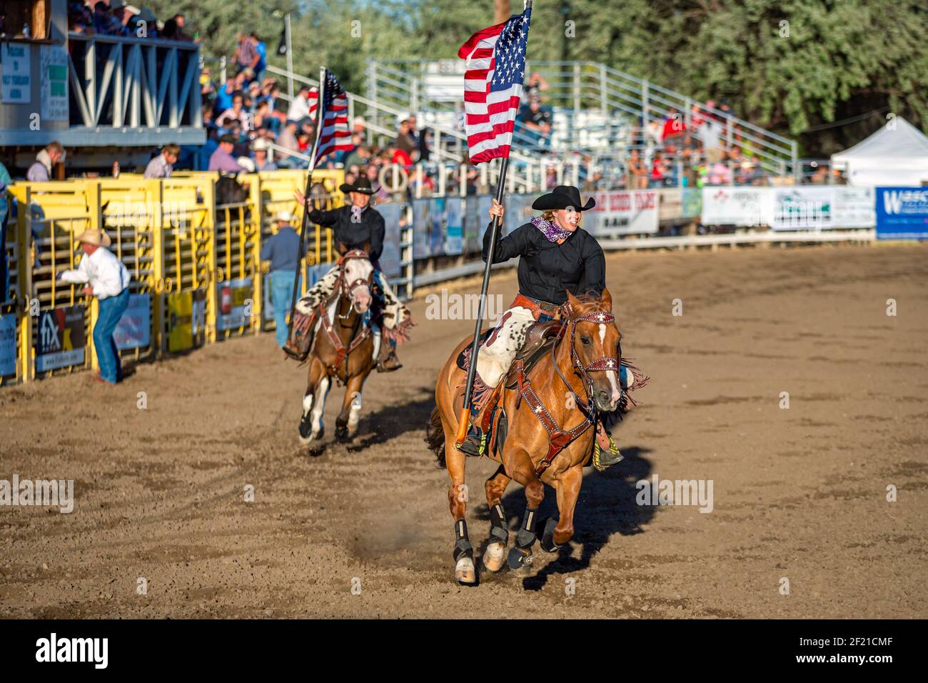 Color guards with American flags at the opening ceremonies of a rodeo ...