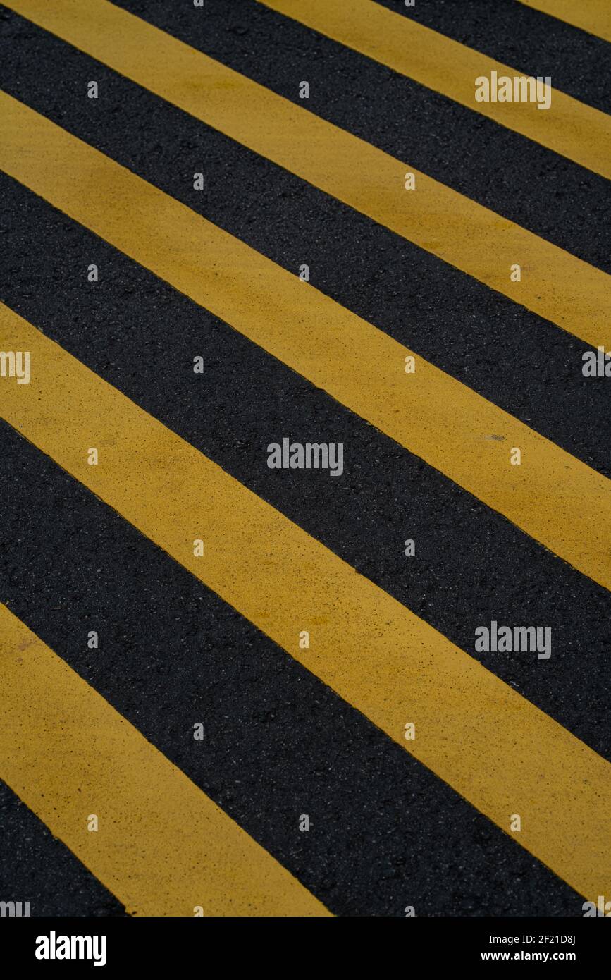Crosswalk zebra crossing pavement. Yellow and black background Stock ...