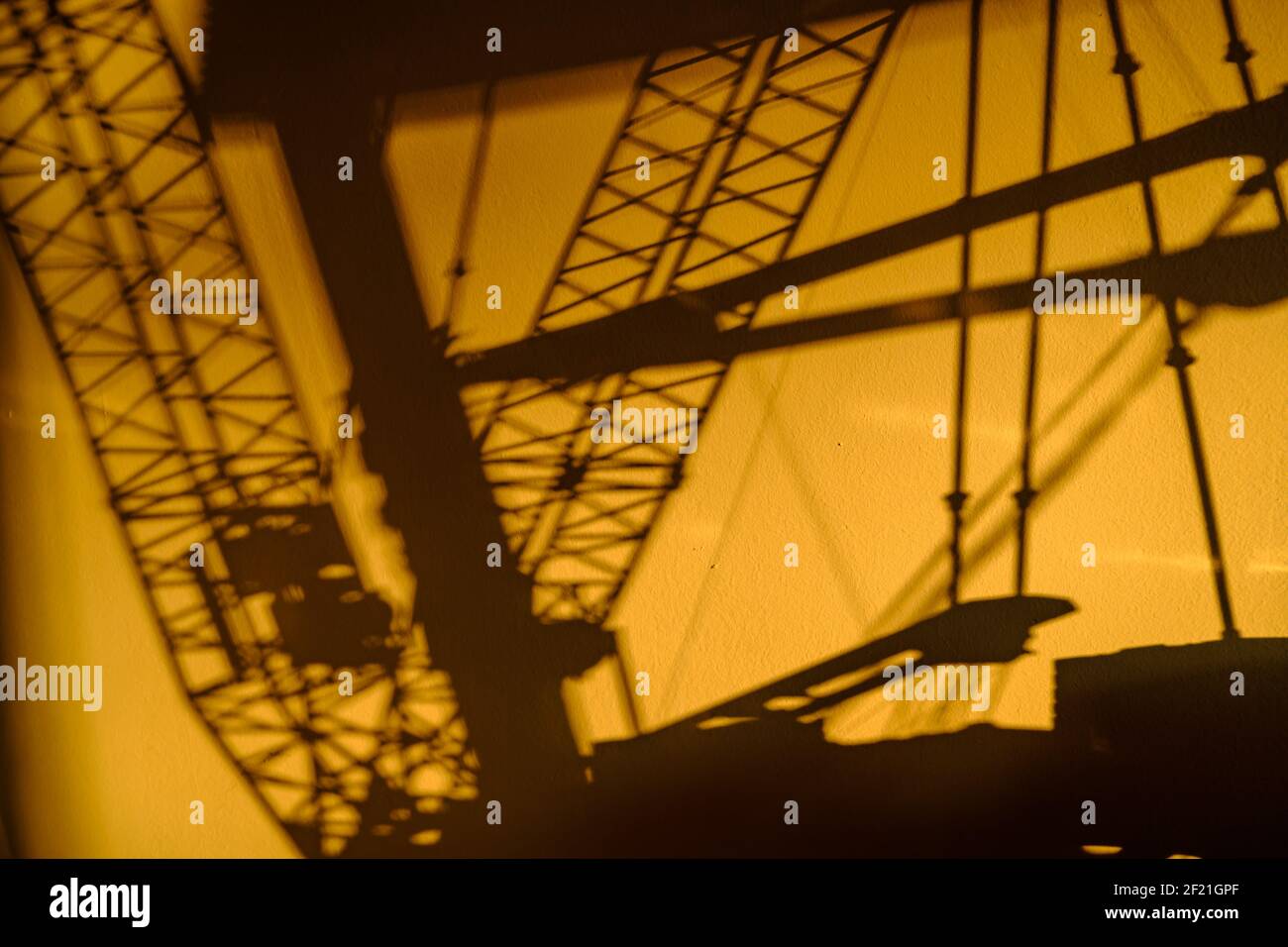 shadow of a lattice boom crane and a telescope crane on the wall Stock ...