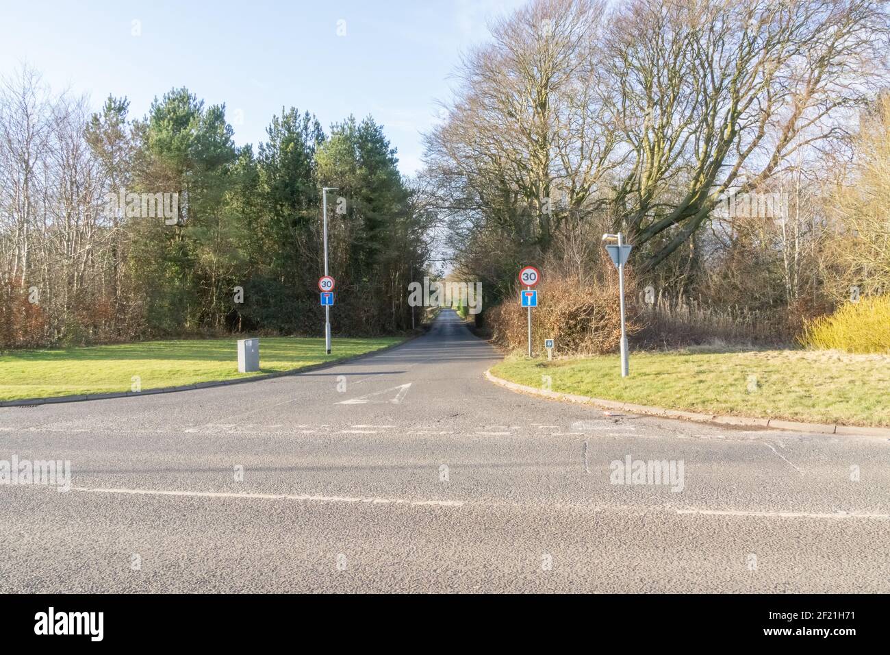 Scottish country footpath leading onto a roadway displaying a 30 mile ...