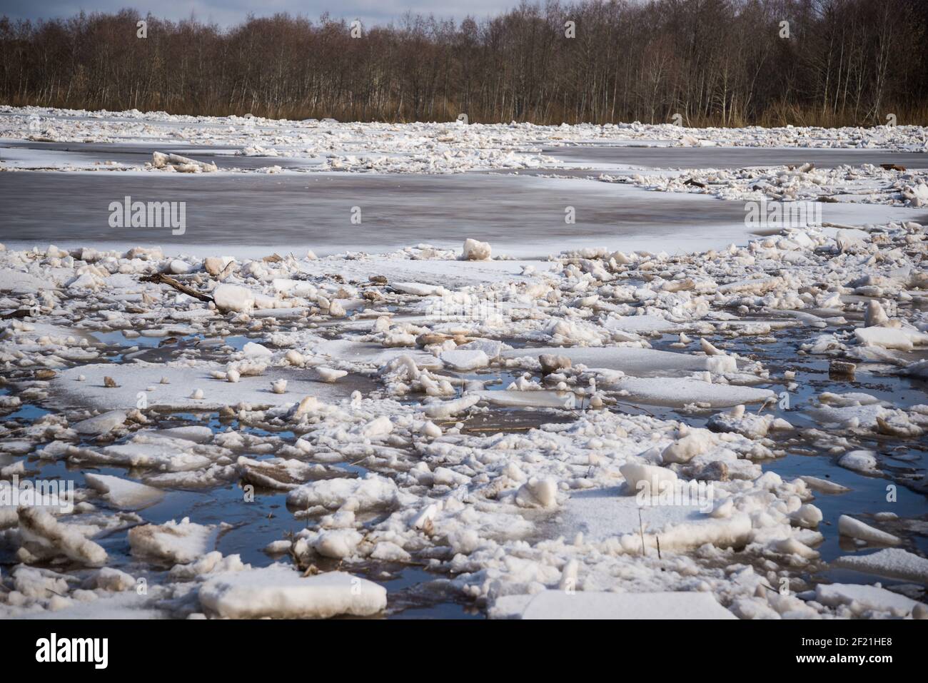 Spring floods. Sedimentation of ice blocks in a river that forms an ice ...