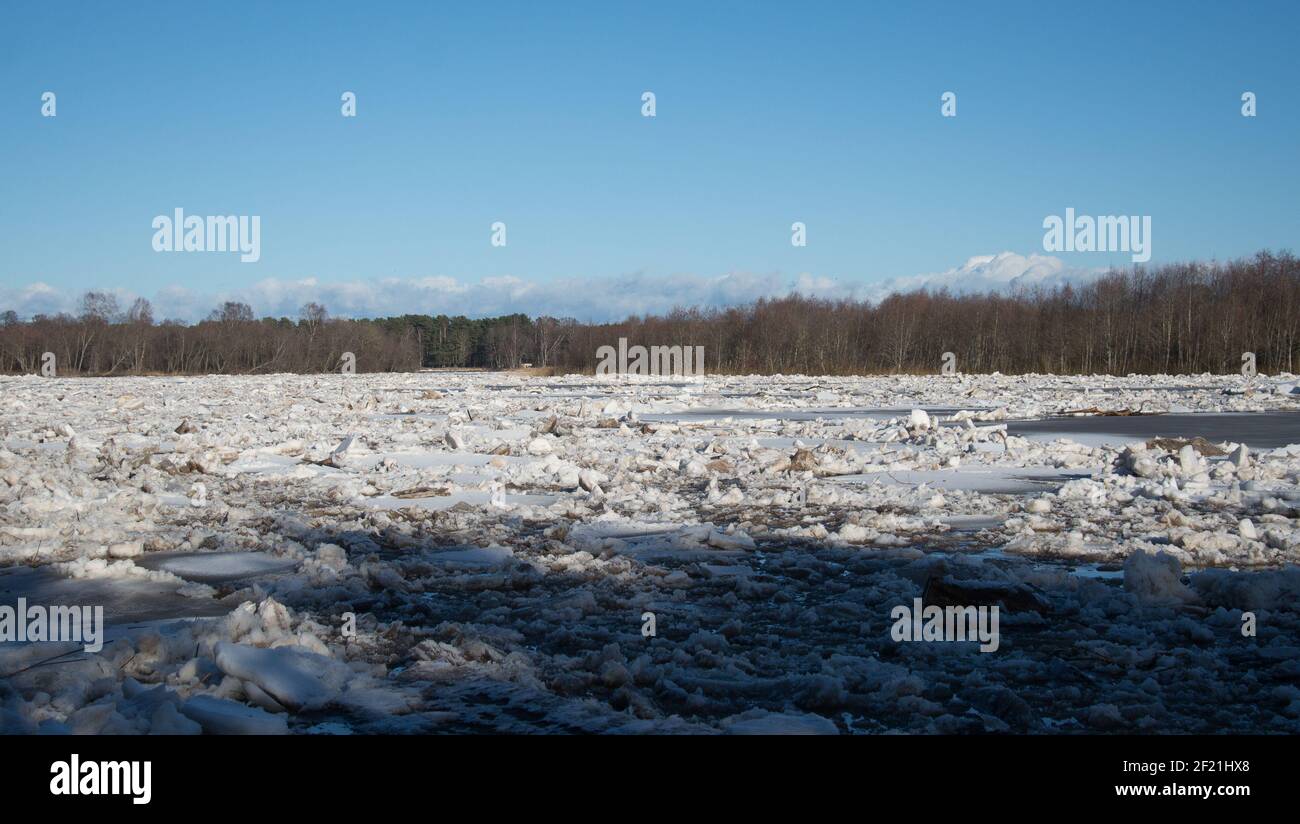 Spring floods. Sedimentation of ice blocks in a river that forms an ice ...