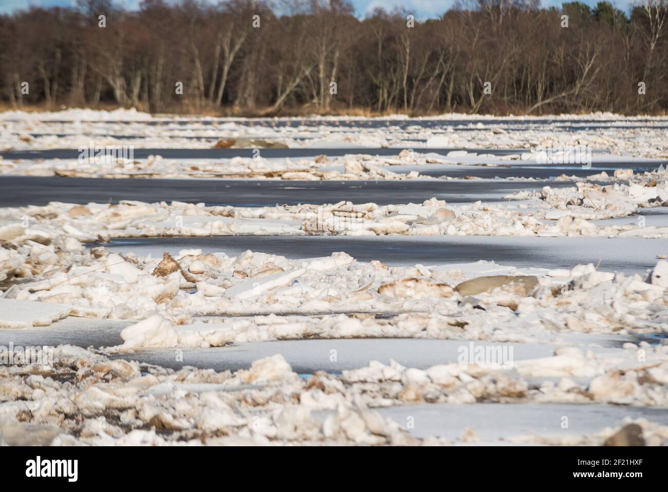 Spring floods. Sedimentation of ice blocks in a river that forms an ice ...