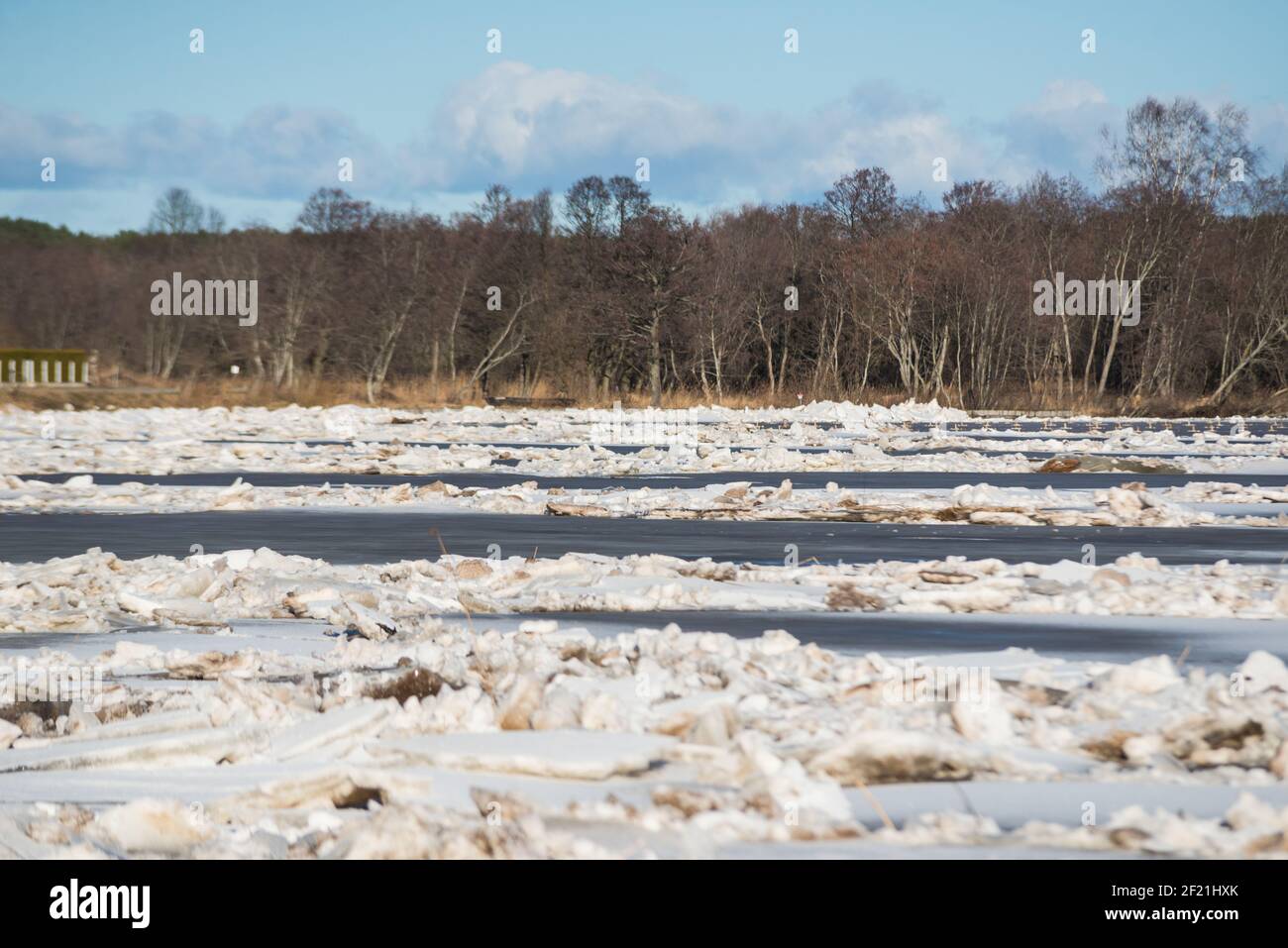 Spring floods. Sedimentation of ice blocks in a river that forms an ice ...