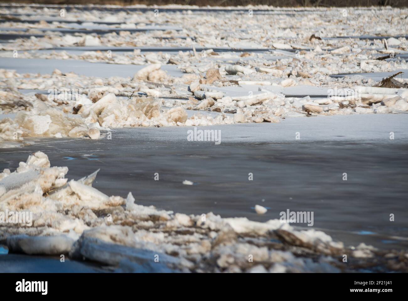 Spring floods. Sedimentation of ice blocks in a river that forms an ice ...