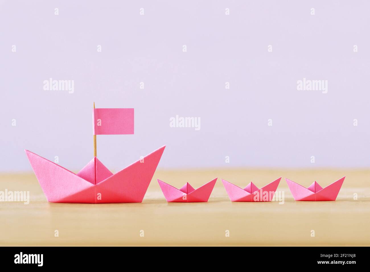 Pink paper boat with flag and three small paper boat - Concept of women ...
