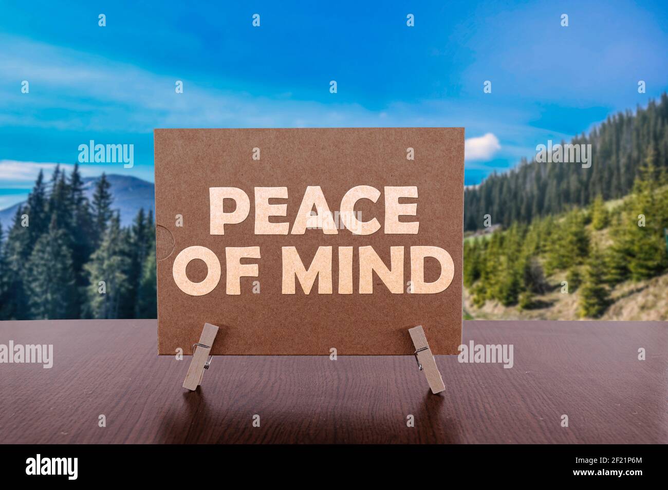 Peace of mind text on card on the table with mountain valley background ...