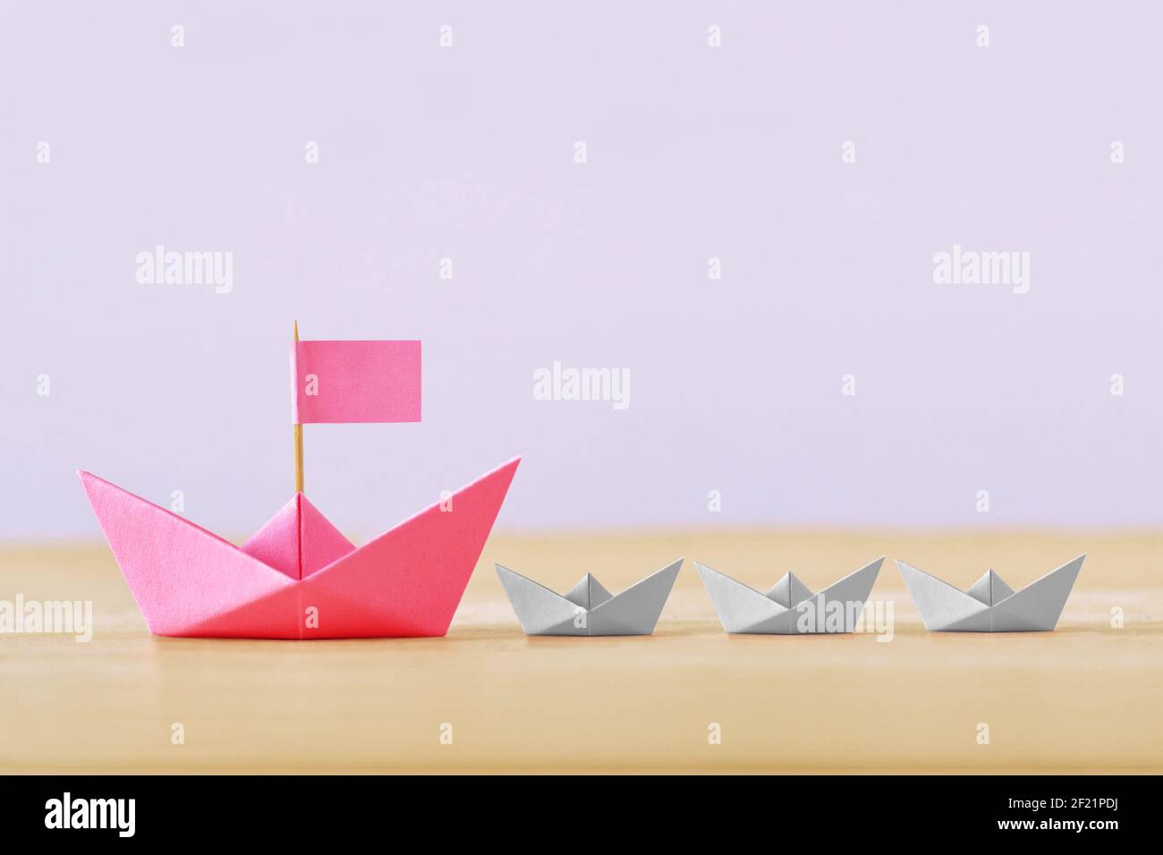 Pink paper boat with flag and three white small paper boat - Concept of ...