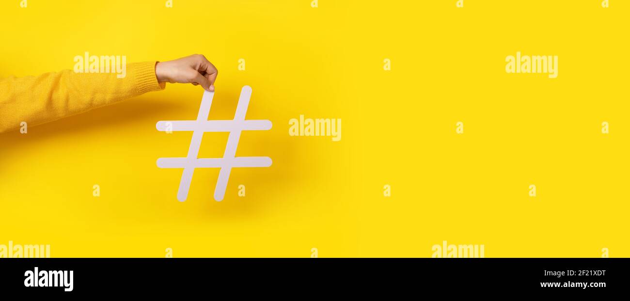 Social media concept, hand holding big white hashtag sign Stock Photo ...