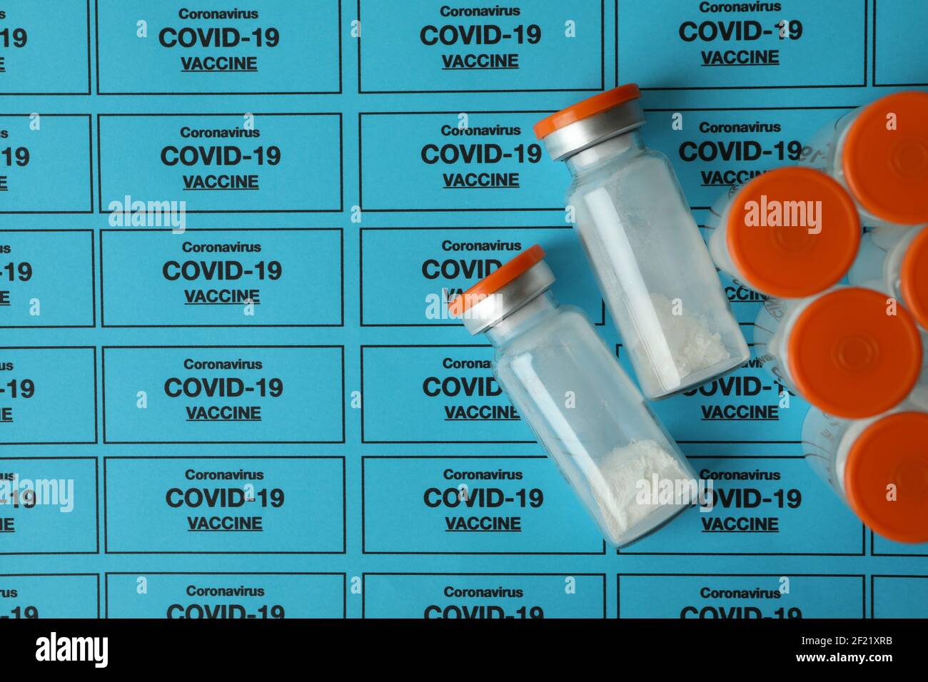Vials of powder Covid - 19 vaccine on blue background Stock Photo - Alamy