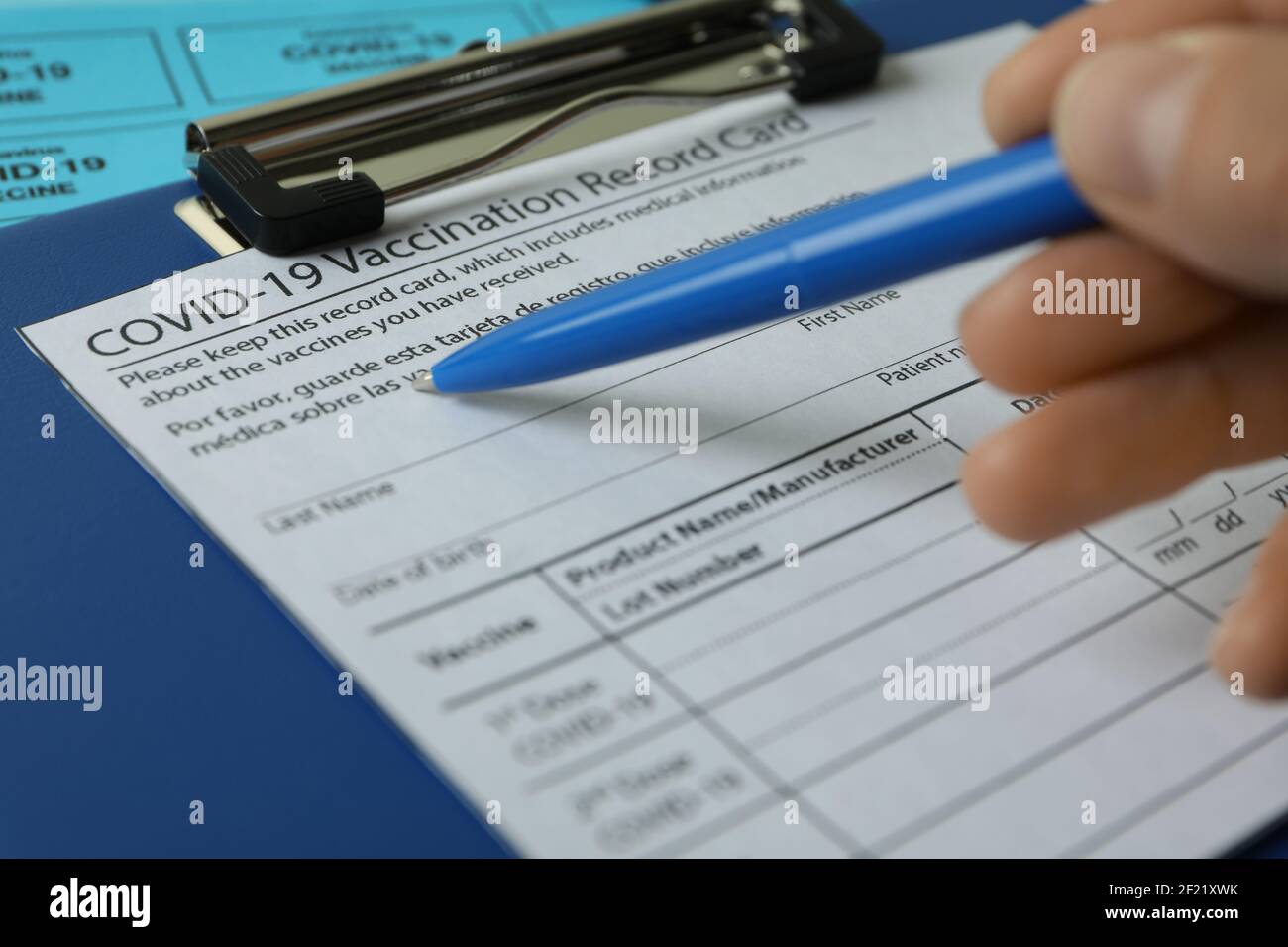 Female hand holds pen on Vaccination record card, close up Stock Photo ...