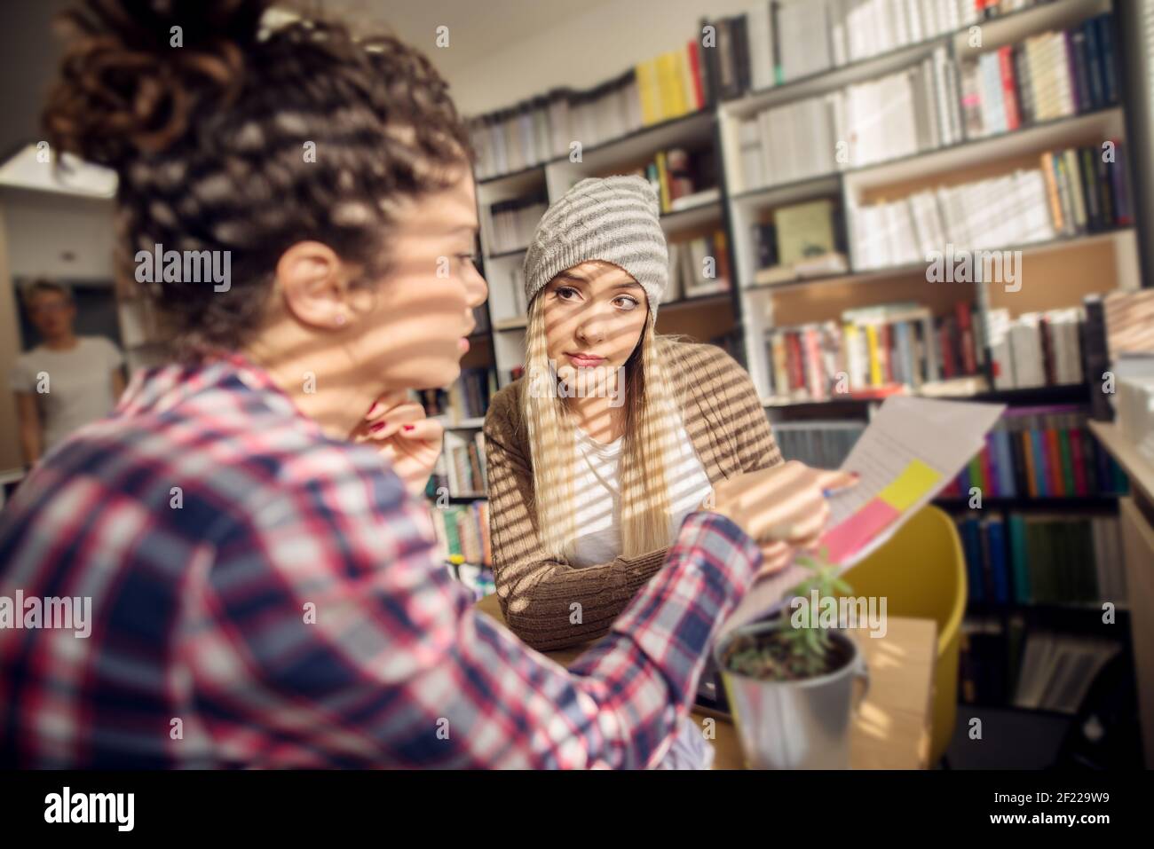 Two beautiful young student girls studying for the big exam in the ...