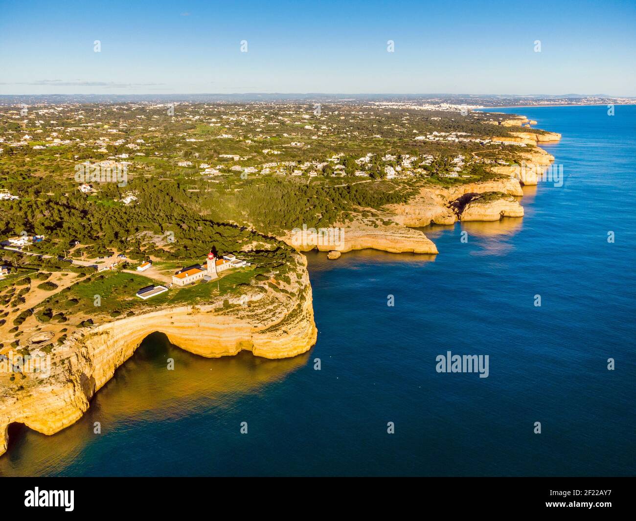 Cliffy coast of Algarve with Alfazinha Lighthouse in Carvoeiro ...