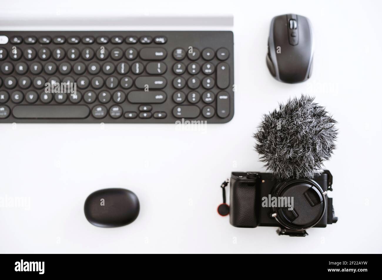 A minimalistic set of vlogger or YouTuber: camera with mic, mouse ...