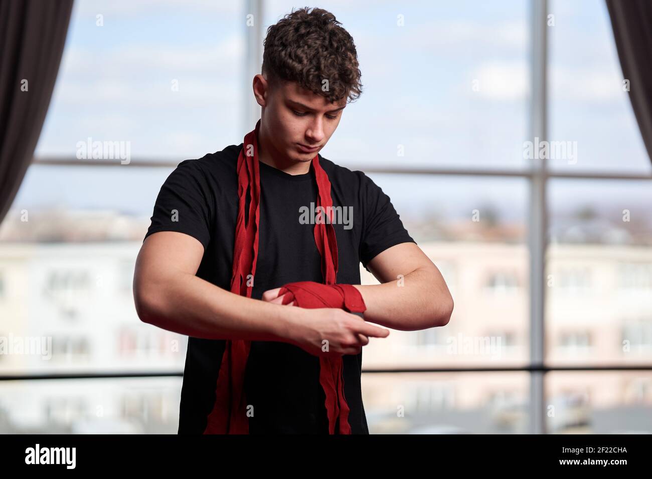Young fighter wrapping his hands for a kickboxing workout Stock Photo ...