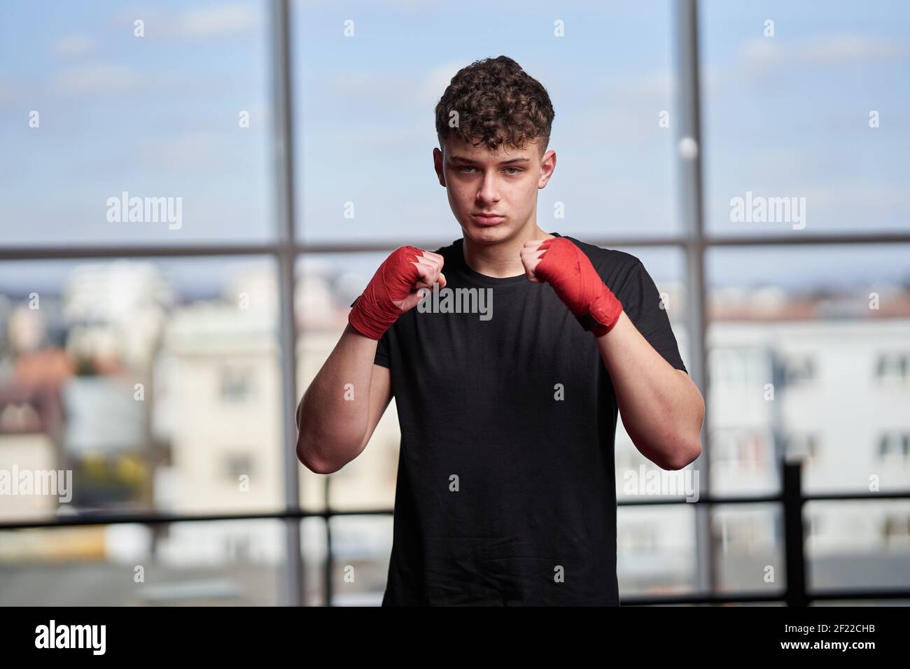 Young kickboxer with hands wrapped doing shadow boxing in the gym Stock ...
