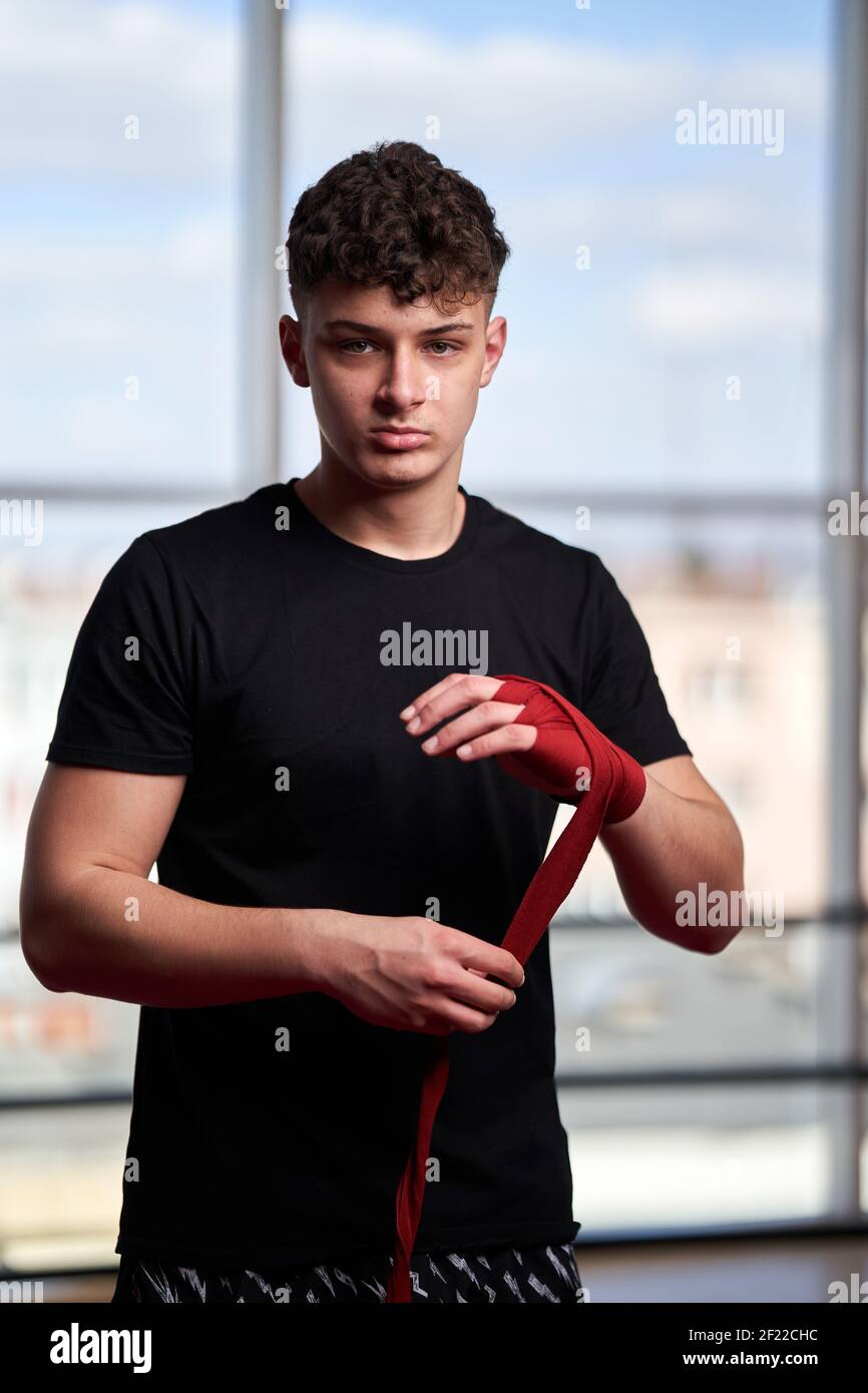 Young fighter wrapping his hands for a kickboxing workout Stock Photo ...
