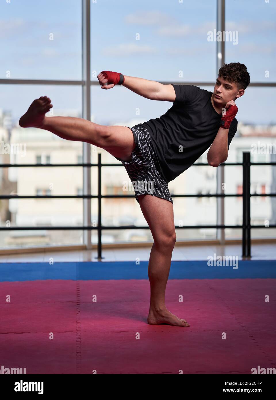 Young kickboxer with hands wrapped doing shadow boxing in the gym Stock ...