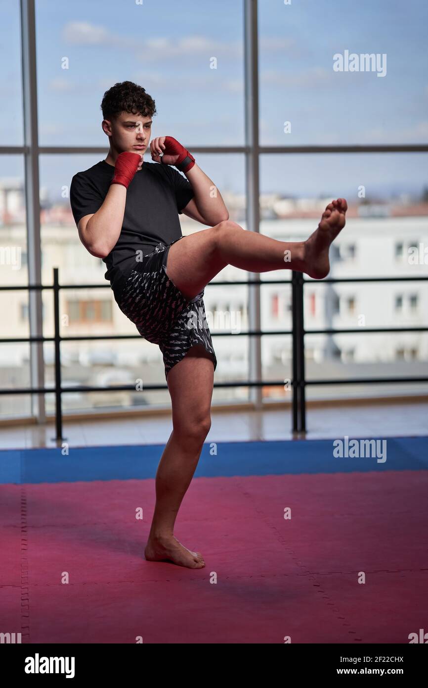 Young kickboxer with hands wrapped doing shadow boxing in the gym Stock ...