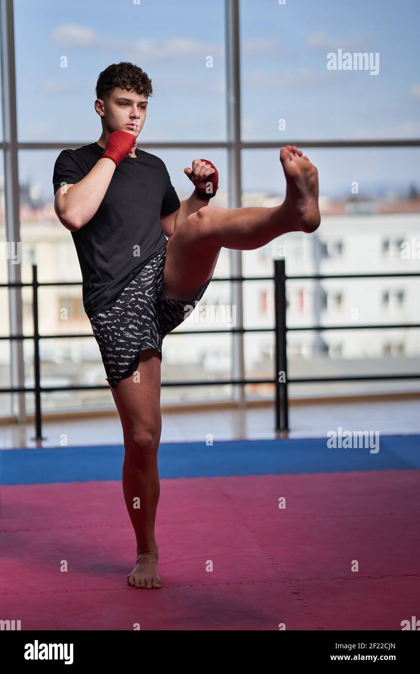 Young kickboxer with hands wrapped doing shadow boxing in the gym Stock ...