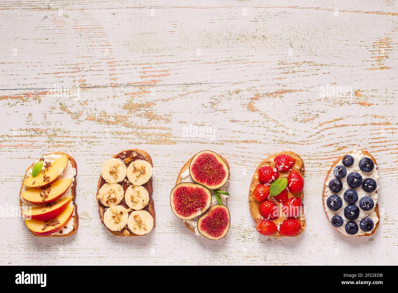 Homemade summer toast with cream cheese, nut butter and fruits and ...