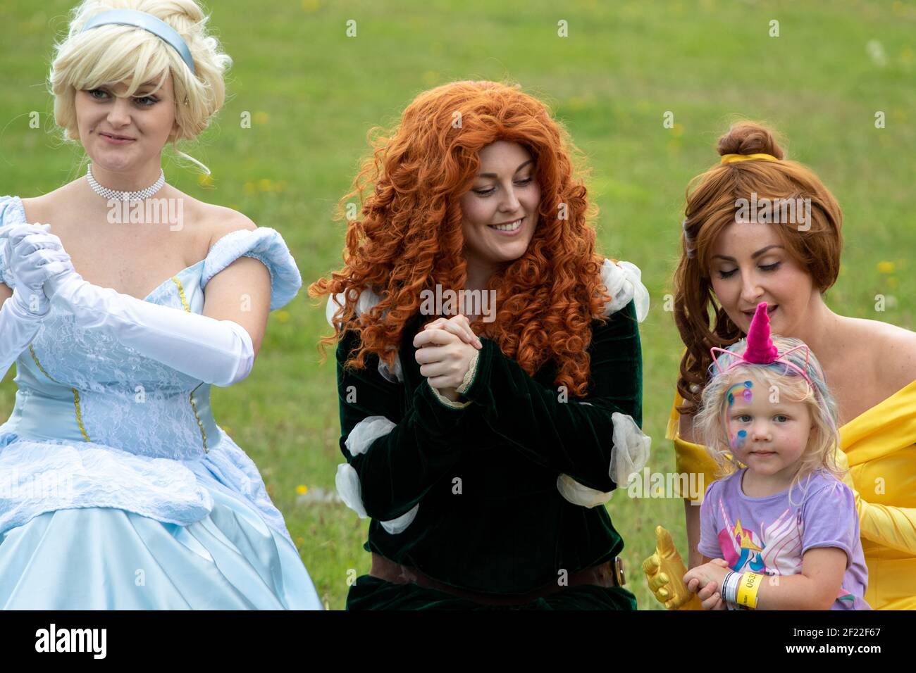 Little girl with Disney Princesses at a charity event Stock Photo - Alamy